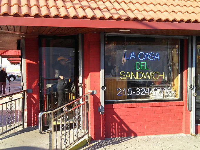 La Casa's neon sign glows like a beacon for sandwich lovers seeking Latin flavors pressed between perfectly crisp bread.
