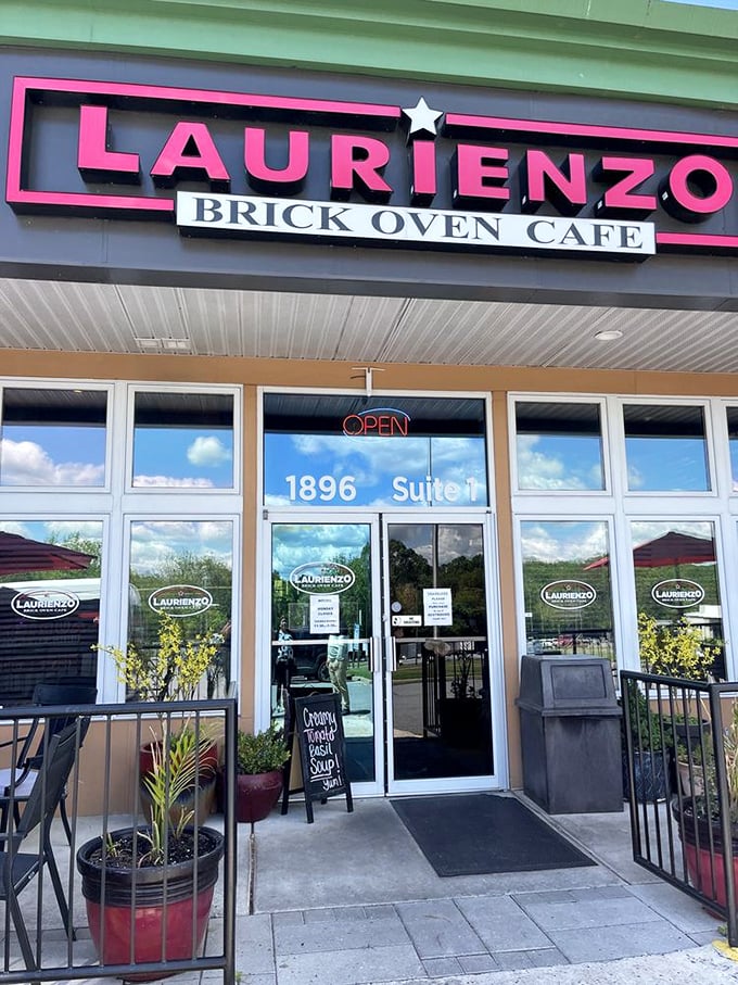 Laurienzo's pink sign pops against the neutral building like a pizza promise. The "Brick Oven Cafe" part tells you everything you need to know.