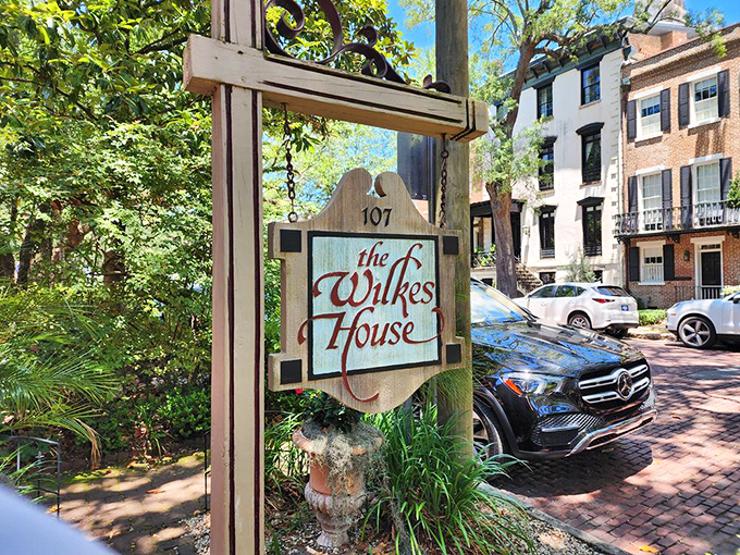 This historic Savannah gem whispers Southern secrets from behind its modest sign and graceful palms.