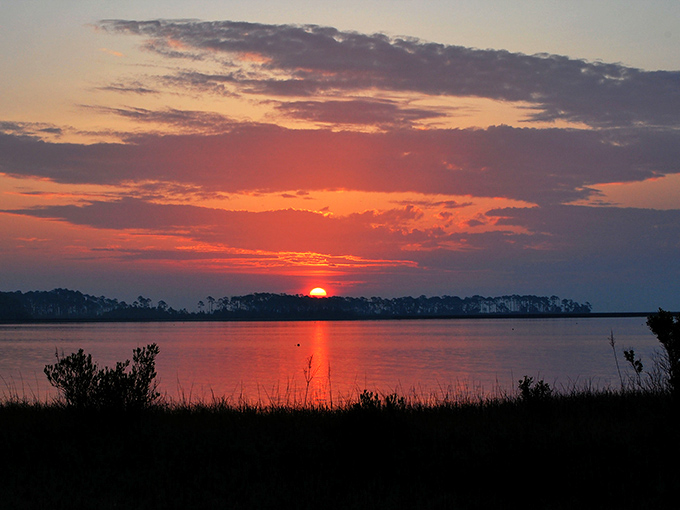 Quiet waters reflecting dramatic skies &ndash; the kind of sunset that makes you stop mid-conversation and just stare.