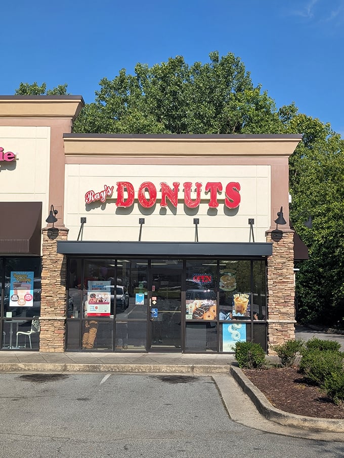 Ray's Donut Shop's stone-accented storefront is like finding a treasure chest in a strip mall. That red sign means sweet rewards await!