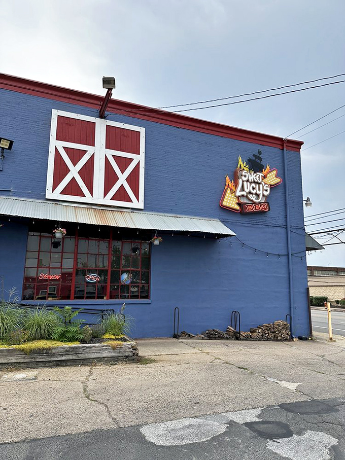 Sweet Lucy's blue exterior with barn-door details stands out like a BBQ oasis. The bright color matches the bold flavors inside!
