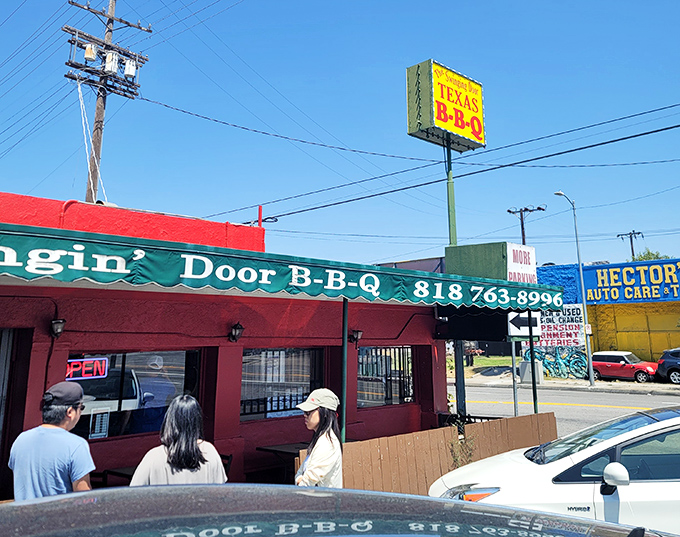 The red building stands like a BBQ lighthouse in the Valley, guiding the hungry to shores of smoky satisfaction.