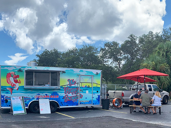 The Happy Snapper's aqua truck with its cartoon mascot is like finding a cheerful oasis of seafood perfection in St. Petersburg's sunny landscape.