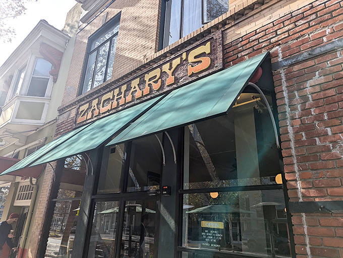 Zachary's brick facade blends historic charm with the promise of creative breakfast magic. That green awning marks the spot where morning dreams come true.