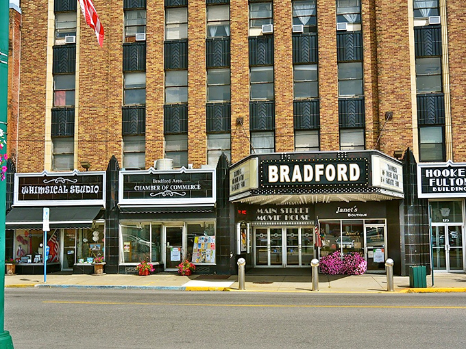 The Bradford Theatre marquee stands as a beacon of affordable entertainment in a town where your dollar still commands respect.