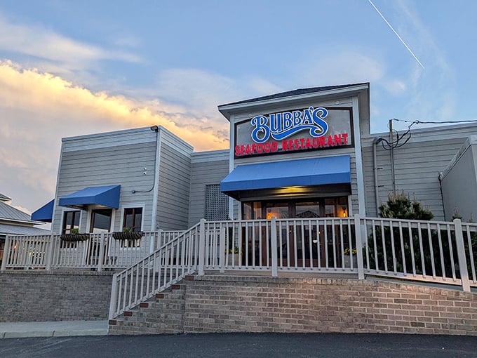 Sunset transforms Bubba's into a seafood cathedral. The blue awnings and glowing sign beckon hungry travelers home.