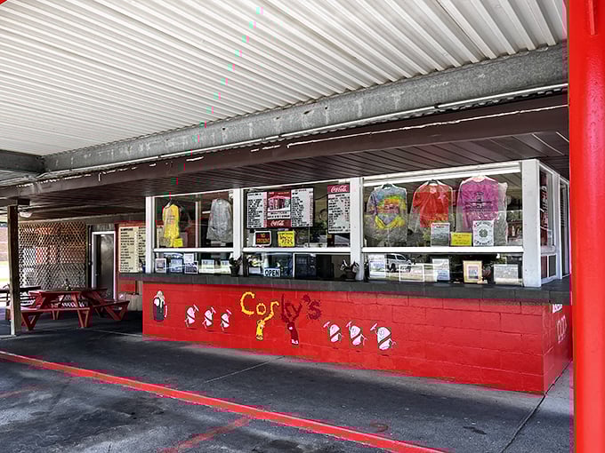 The open kitchen window reveals the theater of food preparation - dinner and a show, drive-in style.