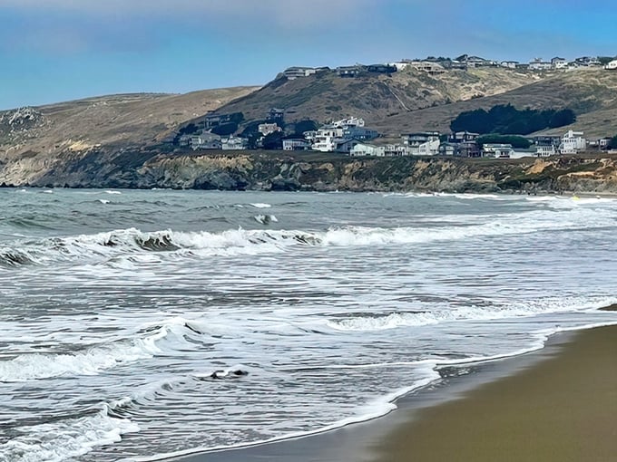 Those rolling hills embrace the coastline like a gentle hug from Mother Nature herself, perfectly peaceful.