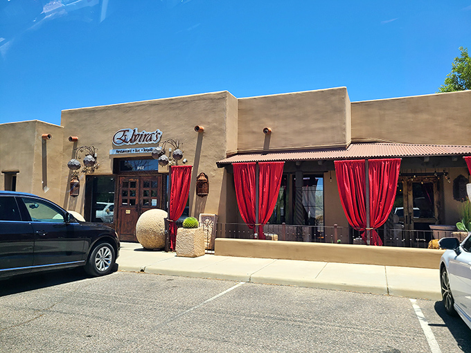 Elvira's earthy exterior with vibrant red patio curtains creates instant curb appeal. Those wooden doors have welcomed countless food pilgrims.
