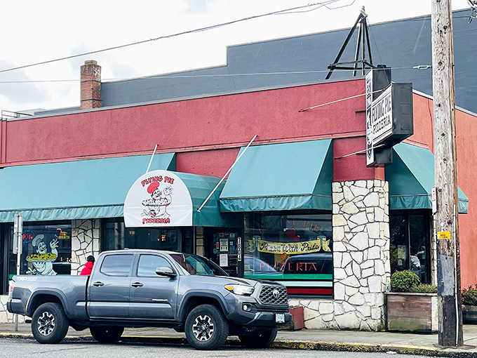 That stone-accented entrance with teal awnings feels like entering a pizza time capsule where the recipes have been perfected for decades.