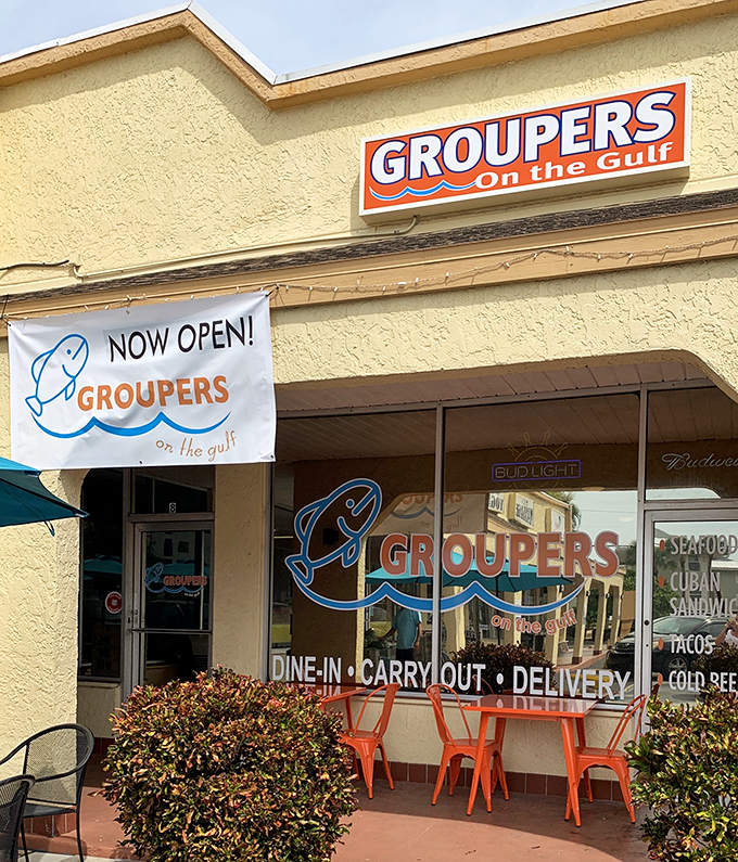 The bright "NOW OPEN" banner is old news to locals, who've kept this place busy since day one. That orange seating is Florida dining at its most honest.