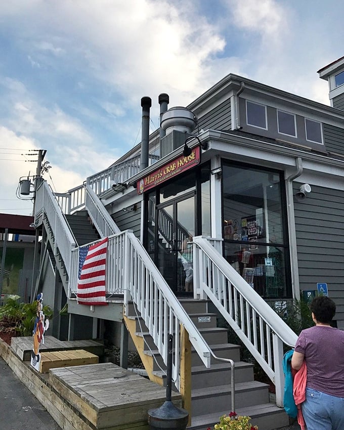 Gray siding, white trim, and a flag that says "seafood served here." Harris Crab House is where boats and appetites dock with equal enthusiasm.