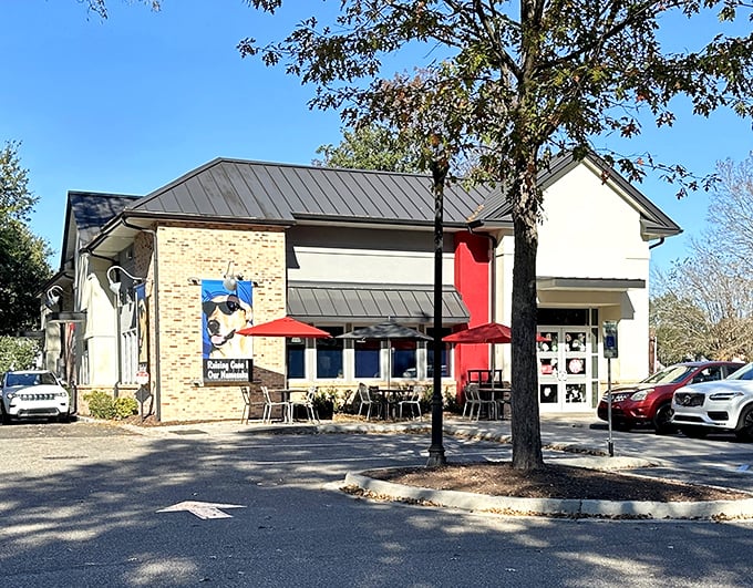Red umbrellas and outdoor seating invite you to enjoy Cane's famous fingers in the Carolina sunshine.