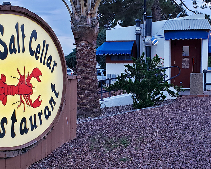 Dusk settles over The Salt Cellar's desert landscape. Descend those steps and discover why locals have kept this seafood hideaway bustling for decades.