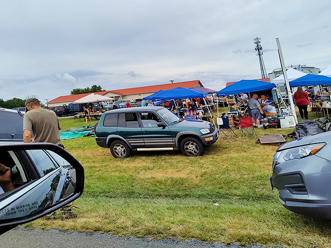 Cars and canopies create the classic flea market landscape. Every parking spot holds potential for amazing finds!