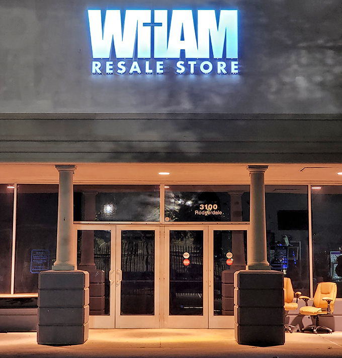 Night transforms WHAM's entrance into a beacon of blue light, guiding evening treasure-seekers to secondhand gold.