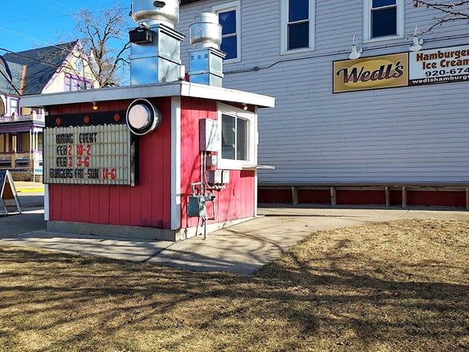 This little red burger command center has been dispatching sliders to happy customers for generations, proving size isn't everything in the burger world.