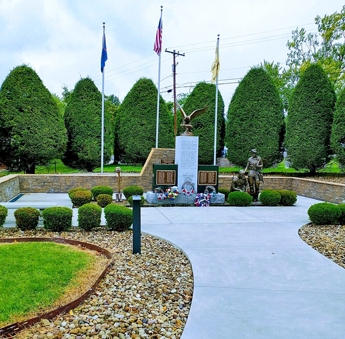 The 14th Quartermaster Memorial offers a quiet moment of reflection, where perfectly manicured hedges stand at attention honoring those who served.