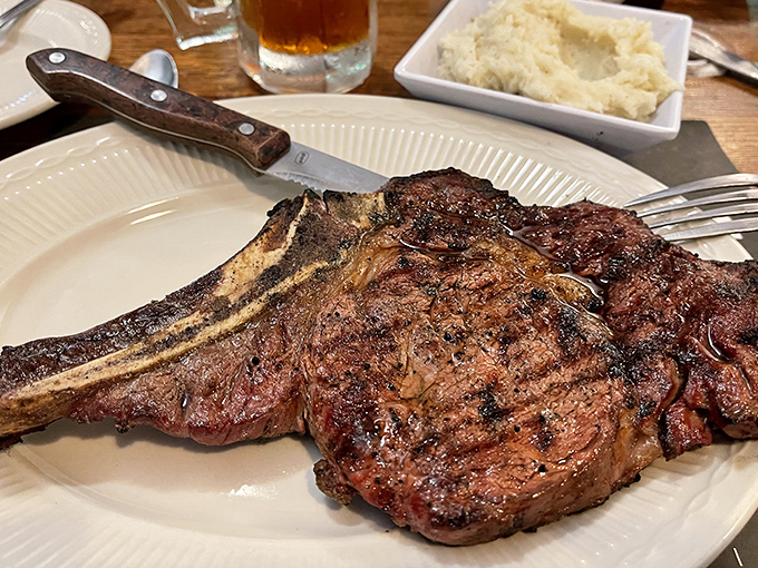 The 20 oz Tomahawk ribeye isn't just a steak—it's a statement piece, a conversation starter, and quite possibly the eighth wonder of the world.