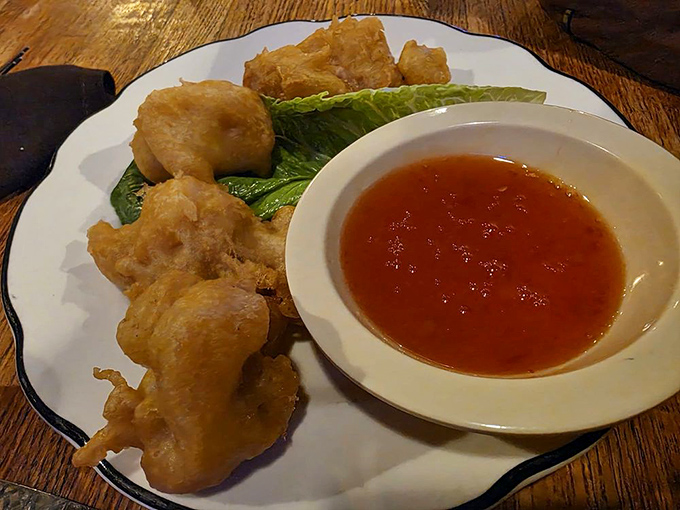 Golden-fried perfection with a dipping sauce that adds just the right zing. These bites are the crispy ambassadors of seafood goodness.