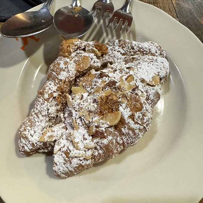 This almond croissant isn't just pastry&mdash;it's edible architecture, with layers that shatter delicately and a dusting of powdered sugar like fresh snow.