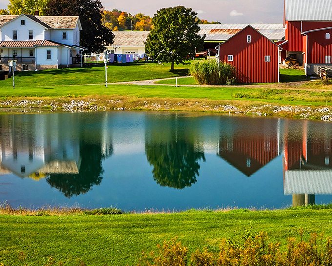 Mirror, mirror on the pond. The perfect symmetry of red barns and white farmhouses reflected in still waters creates nature's own Instagram filter.