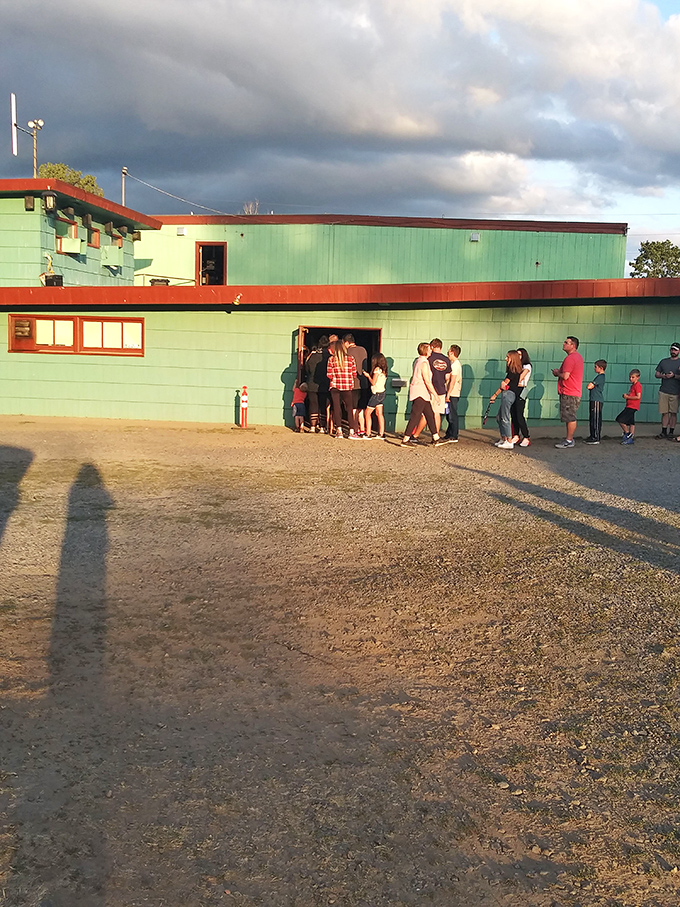 The mint-green concession building draws crowds at twilight&mdash;the intermission pilgrimage for hot dogs and conversation is as essential as the feature presentation.