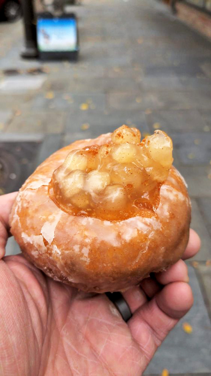 Not just a donut, but a hand-held apple pie experience. The glazed exterior gives way to warm, cinnamon-spiced fruit filling.