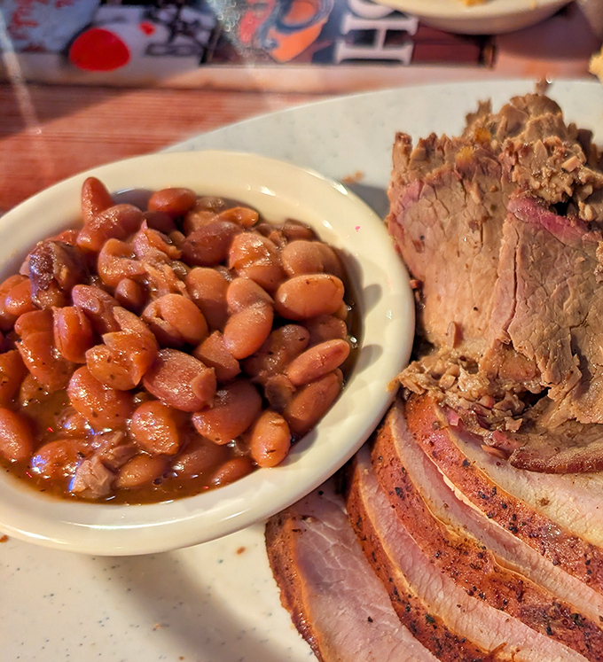 These aren't your average baked beans. They've clearly been simmering with purpose, absorbing smoky flavors while plotting to steal the spotlight from the meat.