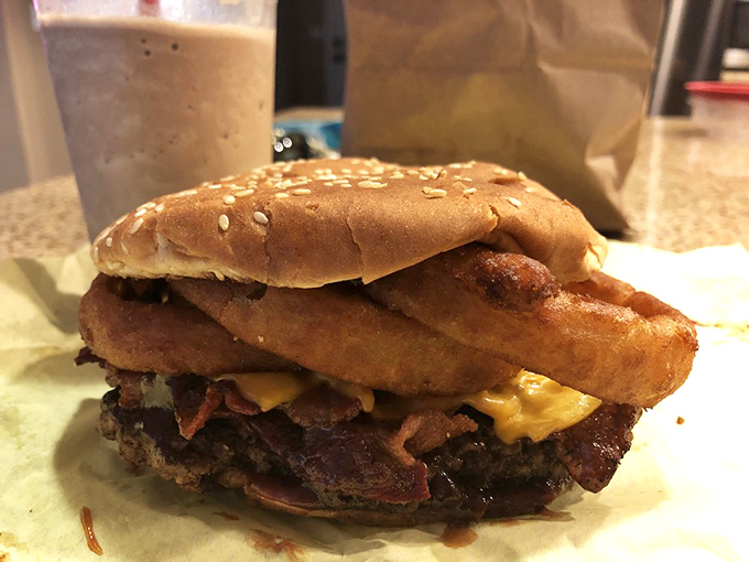 This bacon cheeseburger with onion rings isn't just breaking the rules of proper burger construction&mdash;it's writing delicious new ones.