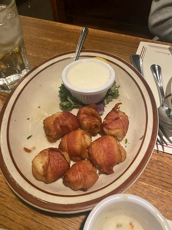 Bacon-wrapped scallops&mdash;where smoky meets sweet in perfect harmony. That dipping sauce isn't just an accompaniment; it's a flavor revelation.