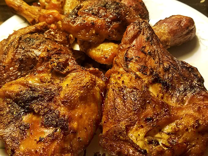 Chicken bearing the beautiful badges of perfect seasoning. That caramelized skin tells stories that fancy restaurants charge triple to hear.