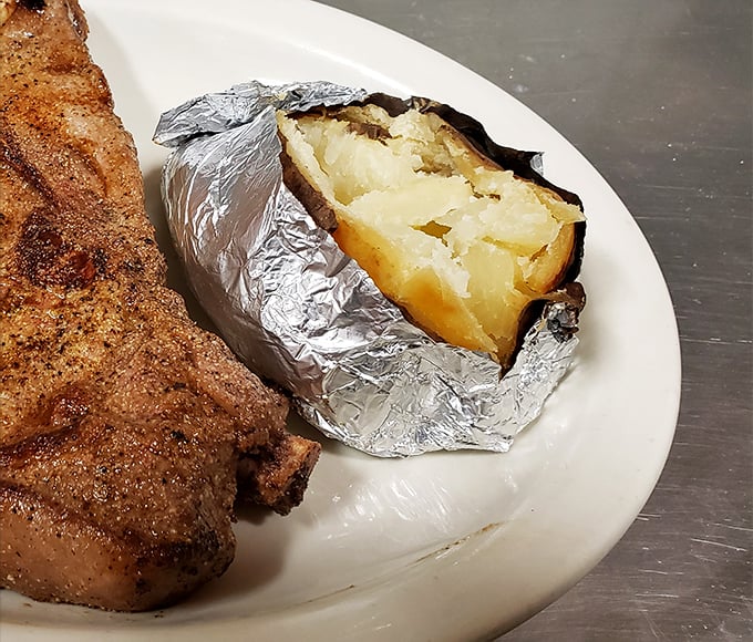 The humble baked potato, wrapped in its silver armor, reveals a fluffy interior that's ready for whatever toppings your heart desires.