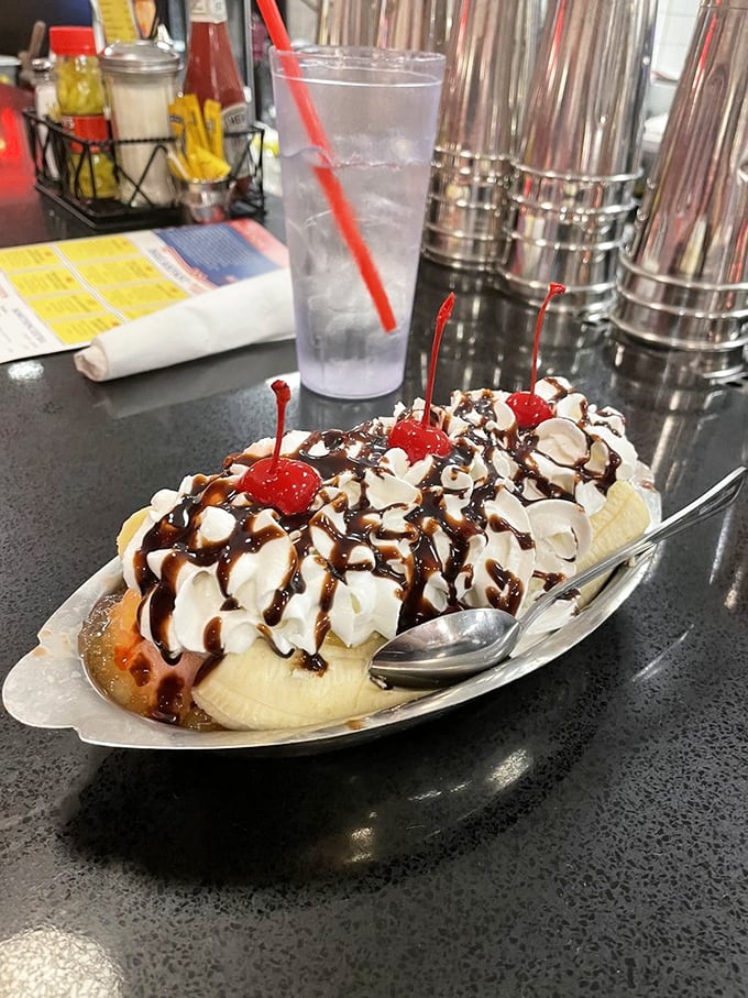 The banana split that launched a thousand road trips. Three scoops of ice cream nestled in a banana boat, drowning happily in hot fudge and whipped cream.