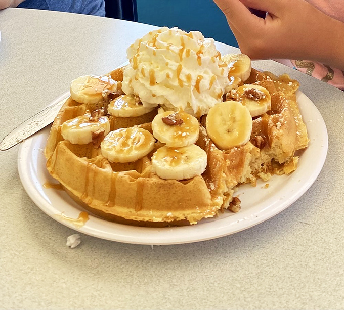 Sweet decadence meets morning comfort as bananas and syrup transform ordinary waffles into extraordinary weekend indulgence experiences.