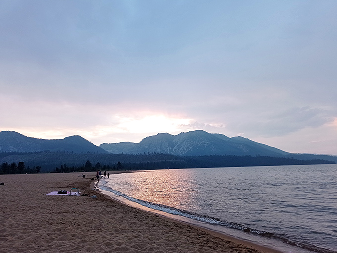 Sunset transforms Emerald Bay's beach into nature's perfect living room, where the mountains provide better entertainment than any flat-screen TV.