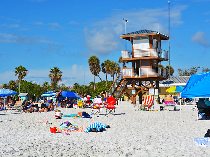 The lifeguard tower stands watch over beachgoers like a friendly lighthouse. Colorful umbrellas dot the sand like sprinkles on the world's most delicious dessert.