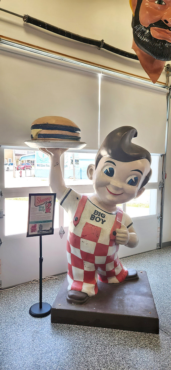 The iconic Big Boy statue, with his checkered overalls and famous pompadour, still hoists that burger skyward&mdash;a fiberglass promise of roadside comfort food.