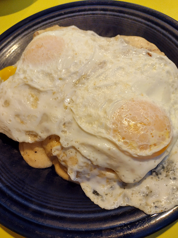 The holy trinity of breakfast bliss: perfectly cooked eggs, sausage with actual flavor, and pancakes that could make a maple tree proud.