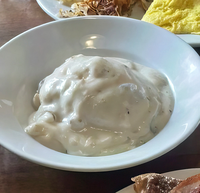 That gravy isn't just white sauce &ndash; it's a silky, peppery masterpiece that transforms ordinary biscuits into the breakfast of champions.