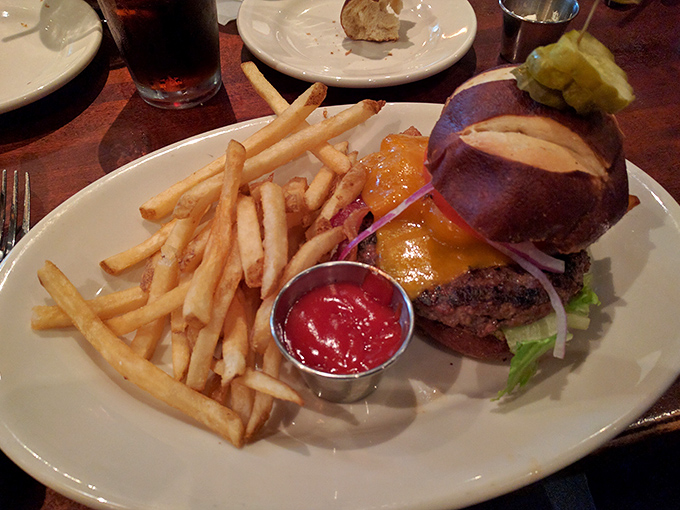 Not all burgers are created equal. This one, nestled in a pretzel bun with cheese cascading down its sides, belongs in the hall of fame.