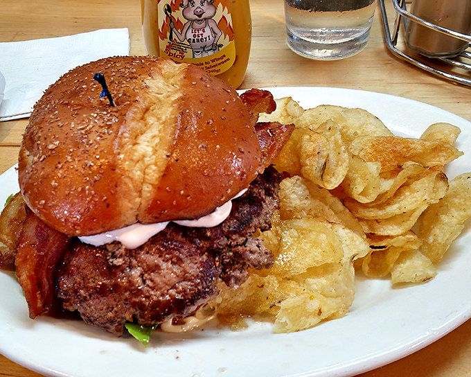 This colossal sandwich isn't just breaking burger boundaries, it's setting up an entirely new sovereign burger nation with those crispy onion rings as loyal citizens.