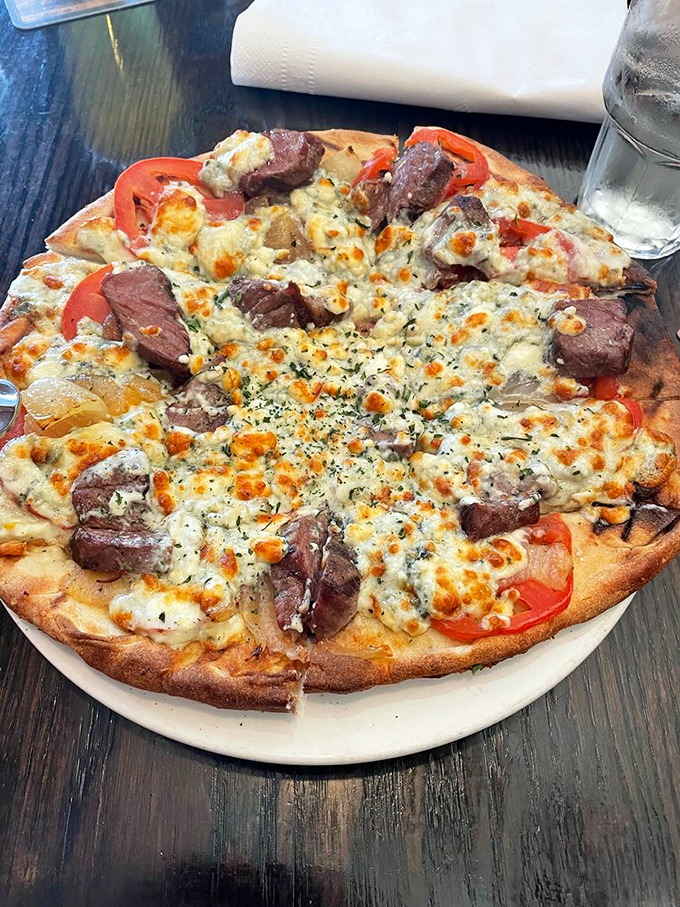 A flatbread that defies gravity with its mountain of toppings. The melted cheese center surrounded by fresh ingredients creates an edible work of art.
