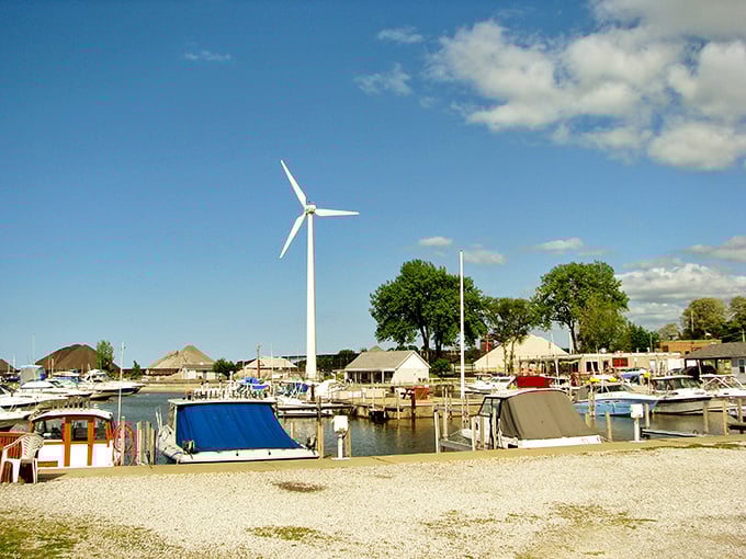 Boats bob gently in Conneaut's harbor while a solitary wind turbine spins tales of sustainable futures on the lake.