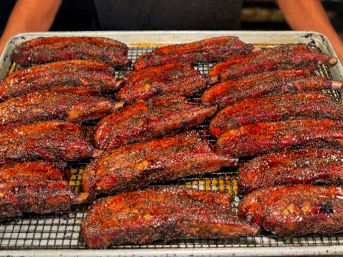 These ribs have been smoking longer than most rock bands. The pink smoke ring is nature's way of saying "perfect."