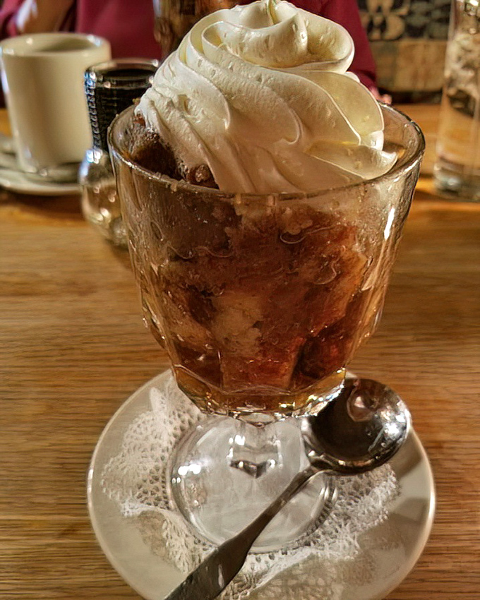 Bread pudding topped with a cloud of whipped cream &ndash; the kind of dessert that makes you consider skipping the main course next time.