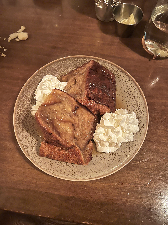 Bread pudding that would make your grandmother simultaneously proud and jealous. The whipped cream isn't decorative&mdash;it's essential to the experience.