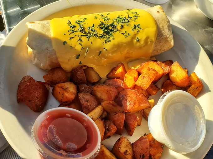Breakfast burrito bathed in cheese sauce with those famous home fries standing guard. This plate doesn't just say good morning&mdash;it sings it.