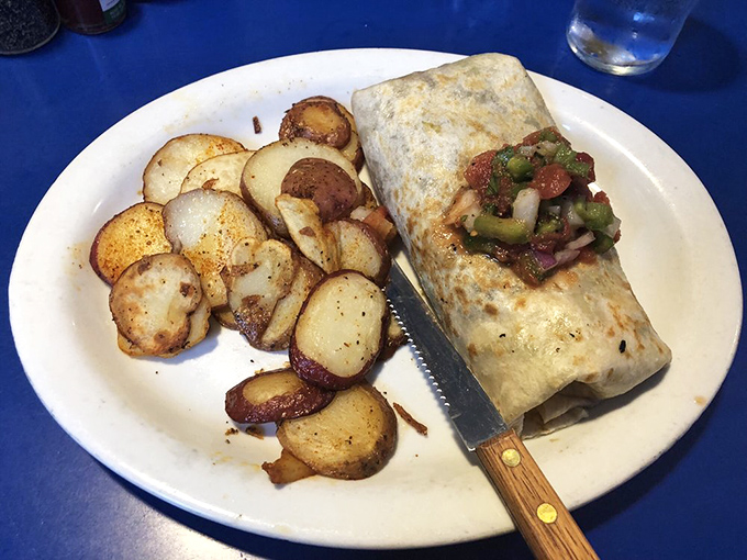 Breakfast burrito perfection with home fries that deserve their own fan club. This knife isn't for protection—it's because some pleasures shouldn't be rushed.